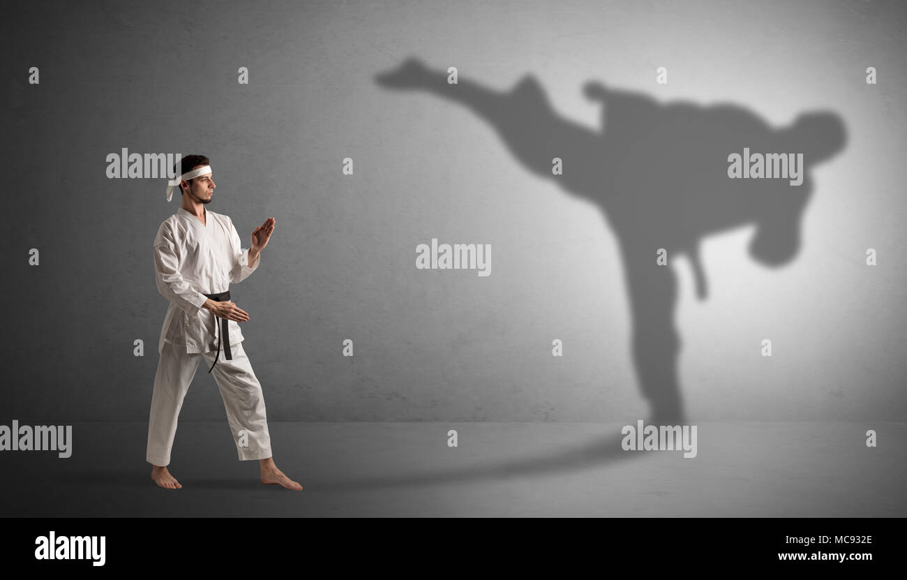 Young karate man confronting with his own shadow Stock Photo - Alamy