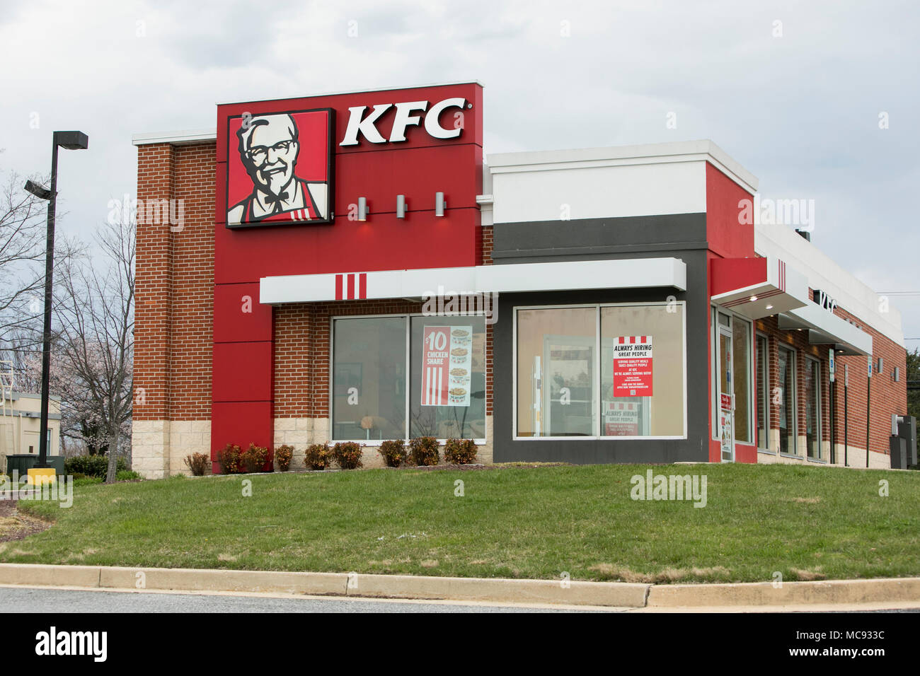 A logo sign outside of a KFC (Kentucky Fried Chicken) fast food ...