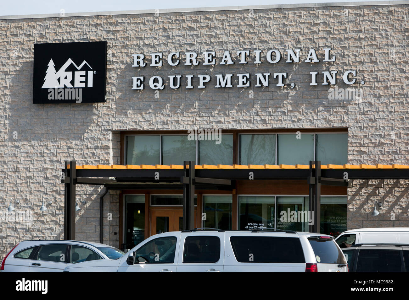 A logo sign outside of a Recreational Equipment, Inc., commonly known ...