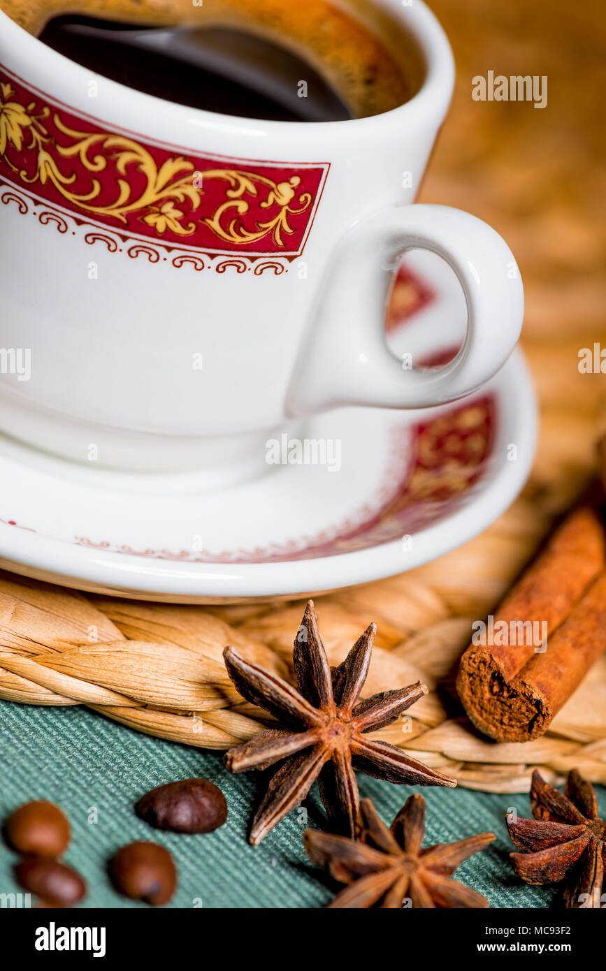 vertical still life delicious coffee in a beautiful cup with spices of ...