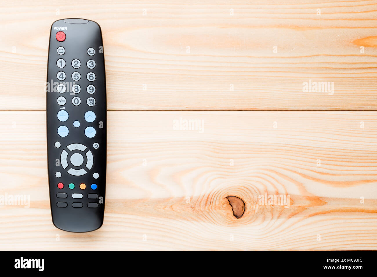remote control for switching channels on the TV set on the wooden floor ...