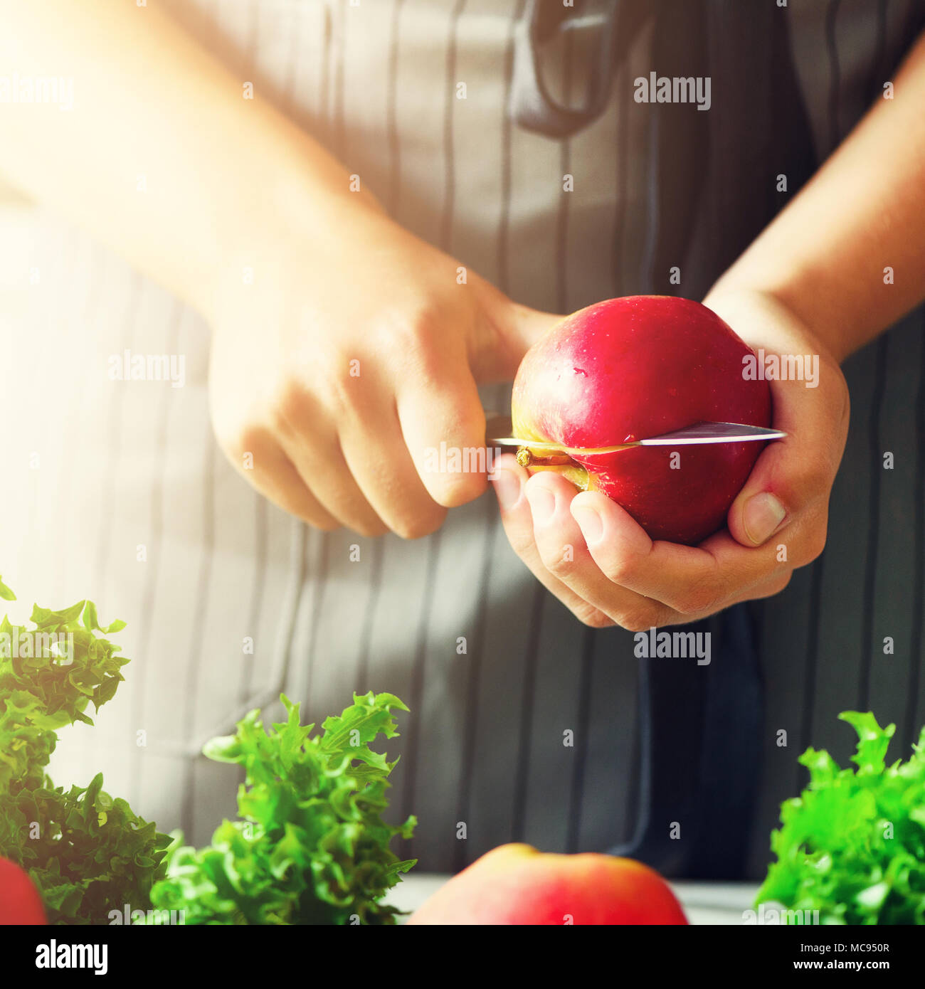 Woman hands cutting, chopping apple for green smoothie. Homemade ...
