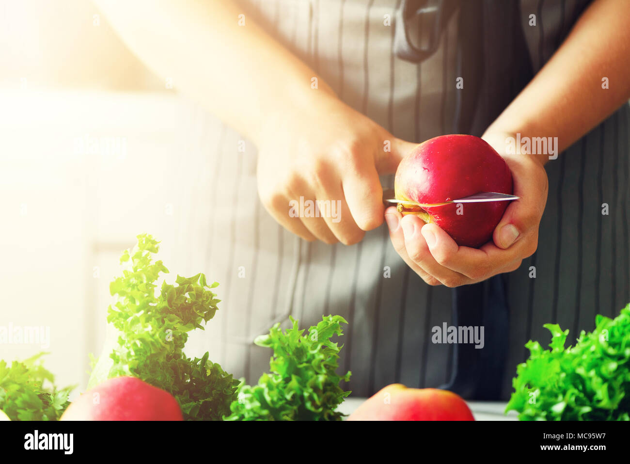 Woman hands cutting, chopping apple for green smoothie. Homemade ...