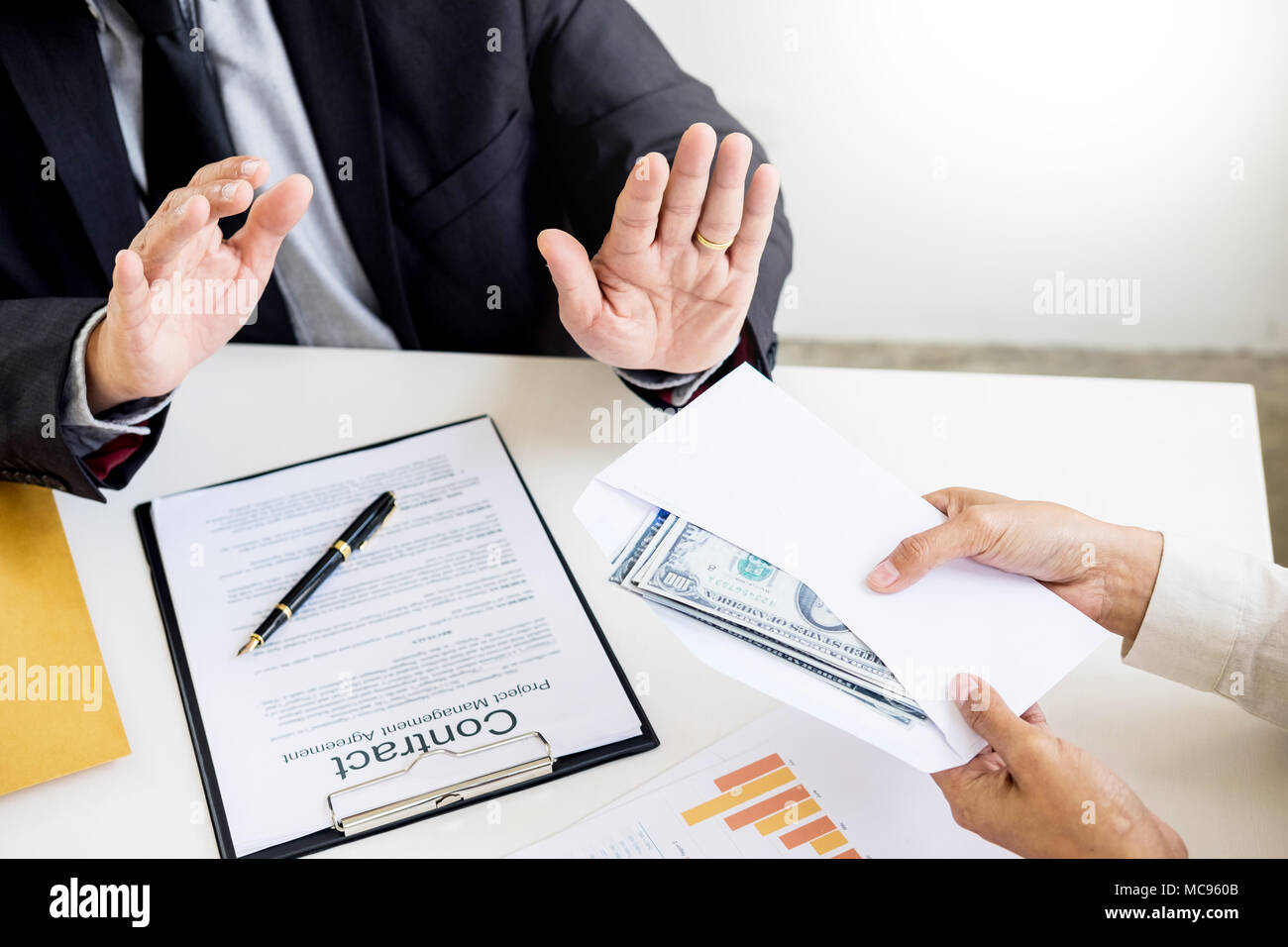 Businessman refusing or rejecting money in the envelope - anti bribery ...