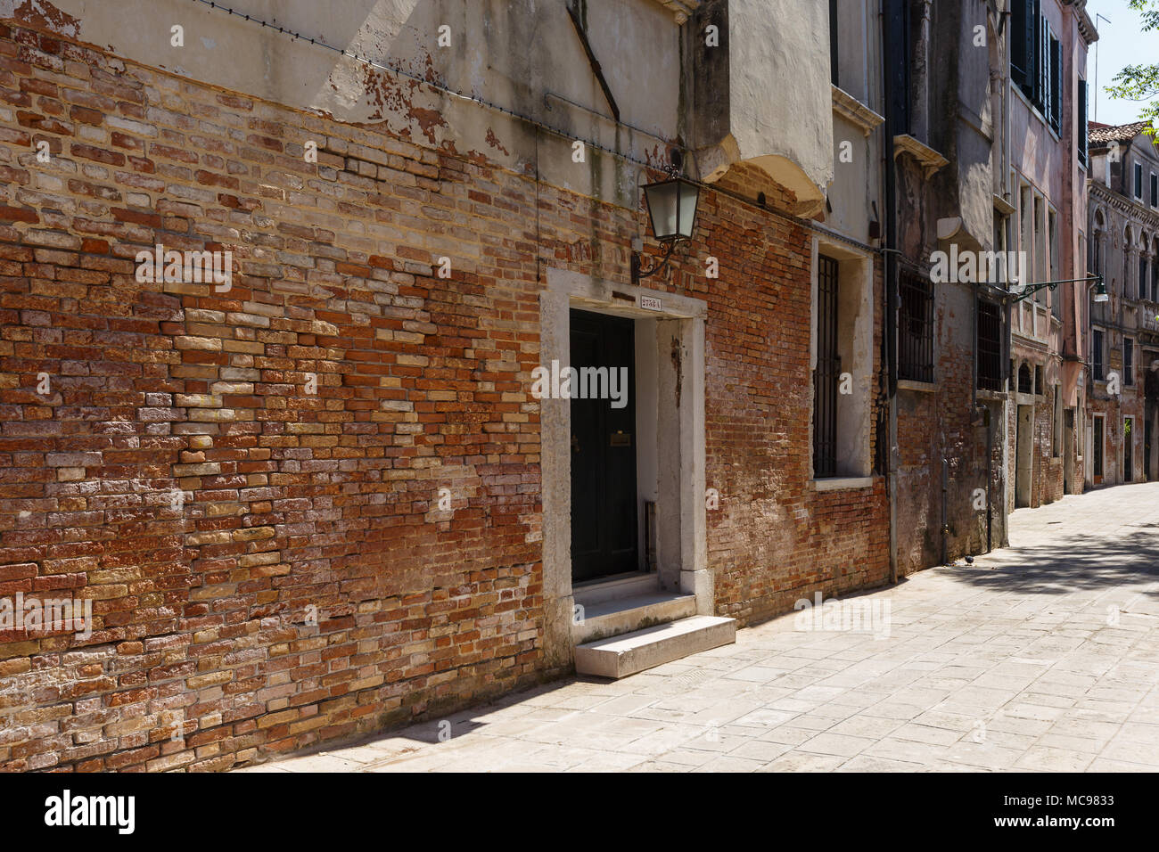 Venice, Italy - June, 21, 2013:Typical view of a narrow Venice street ...