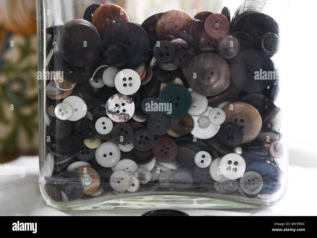 Lots of buttons are pictured inside a glass jar Stock Photo - Alamy