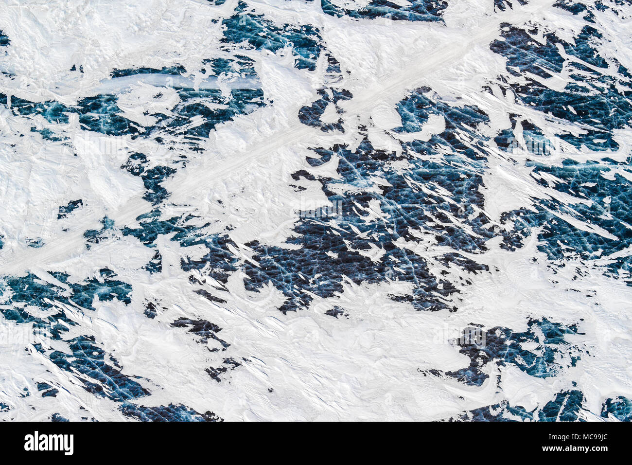 Aerial view of a frozen lake in the Arctic showing patterns of the ice ...