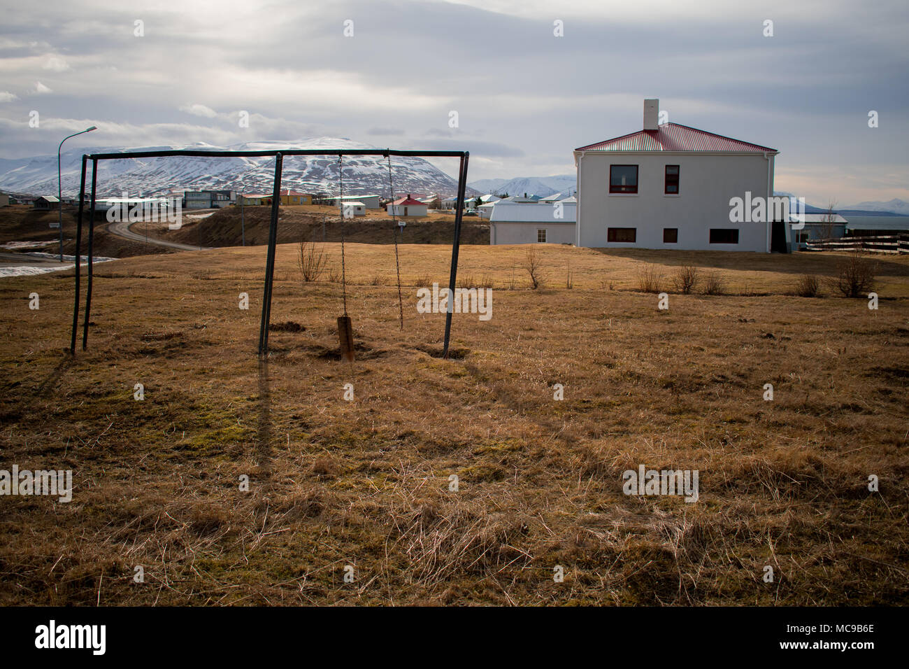 a broken swing at a house's backyard Stock Photo - Alamy