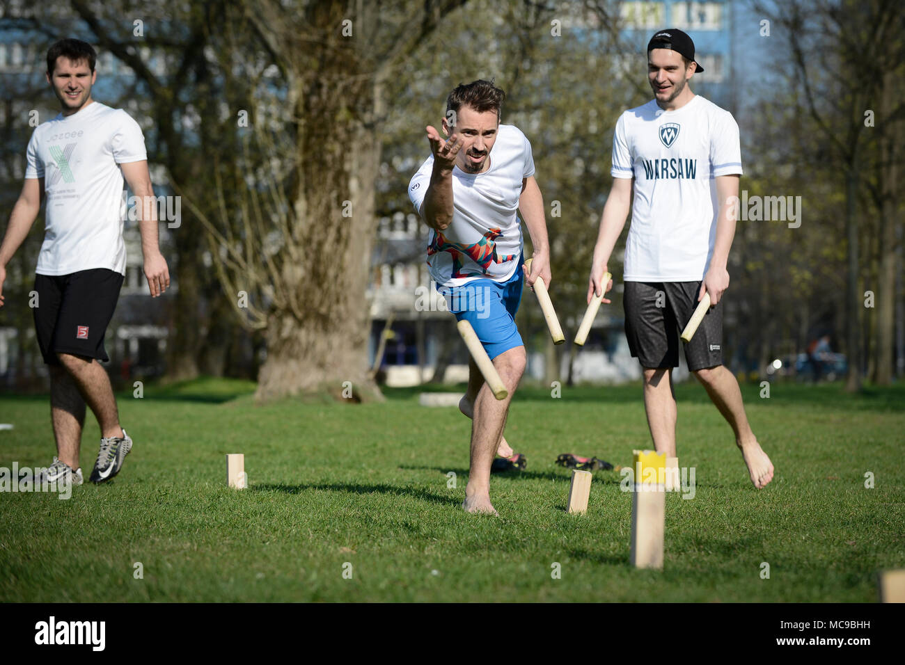 People are seen playing the Kubb lawn game in Mokotowski Park in Warsaw ...