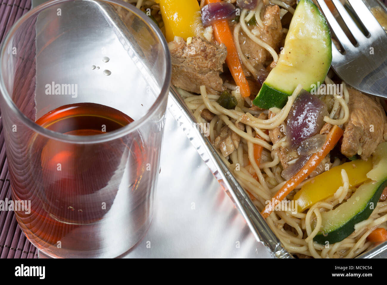Chinese takeaway of Chicken noodle stir fry in a foil delivery dish ...