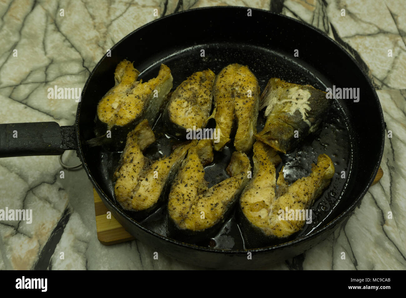 Fish cut into fried pieces Stock Photo - Alamy