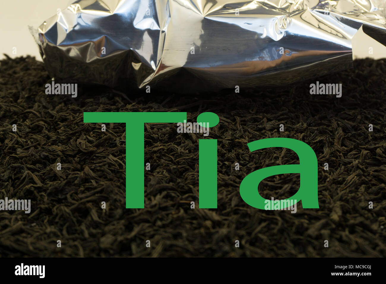Dry black tea leaves. Isolated on white background. Inscription, word ...