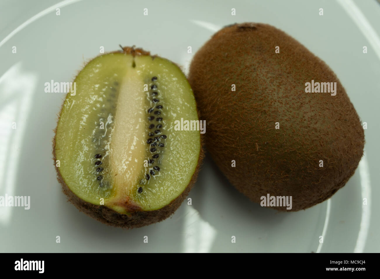 Whole kiwi fruit and half of kiwi isolated on white background Stock ...