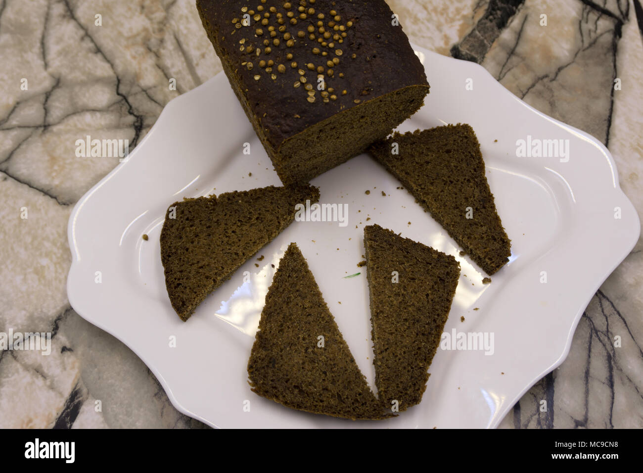 Cutting delicious homemade black bread. Borodinsky bread is a ...