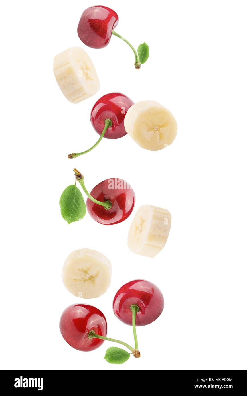 Isolated falling fruits. Falling banana and cherries isolated on white ...