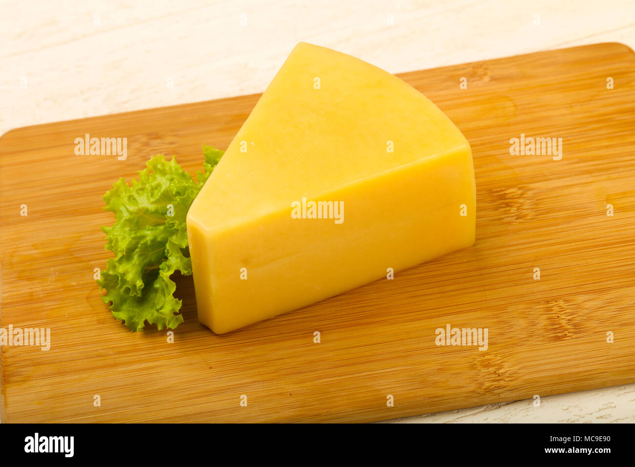 Parmesan cheese triangle Stock Photo - Alamy
