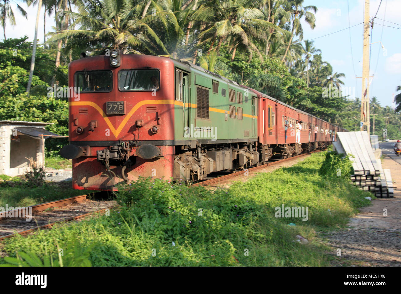 A train passing some coconut palm trees on it's way to Colombo, Sri ...