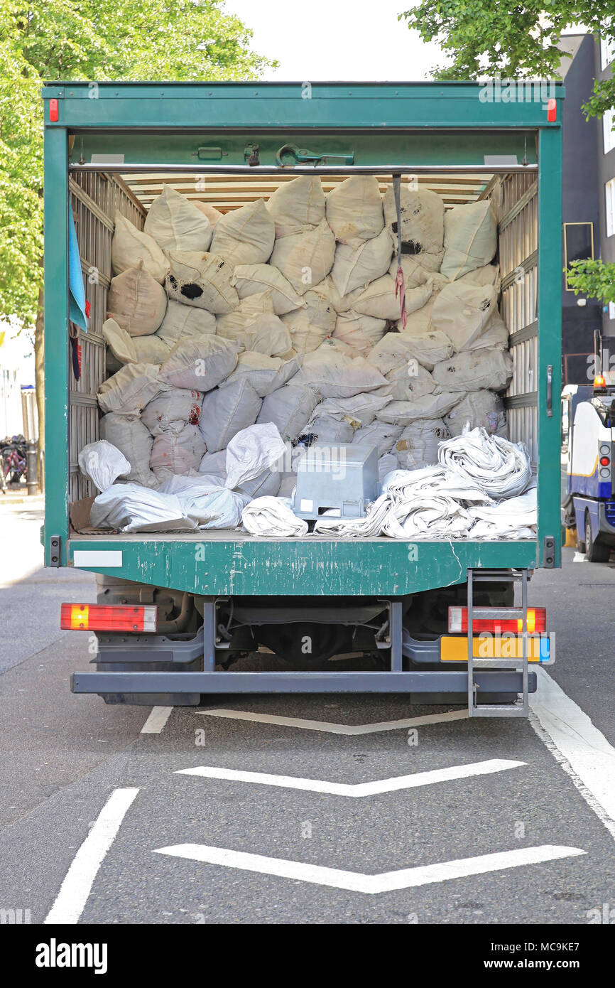 Big Delivery Truck Collecting Laundry Bags Stock Photo - Alamy