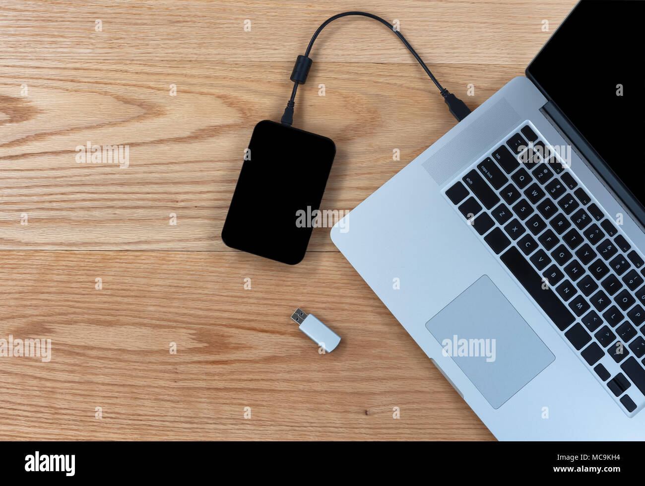 Computer with external USB data storage device on oak desk Stock Photo ...