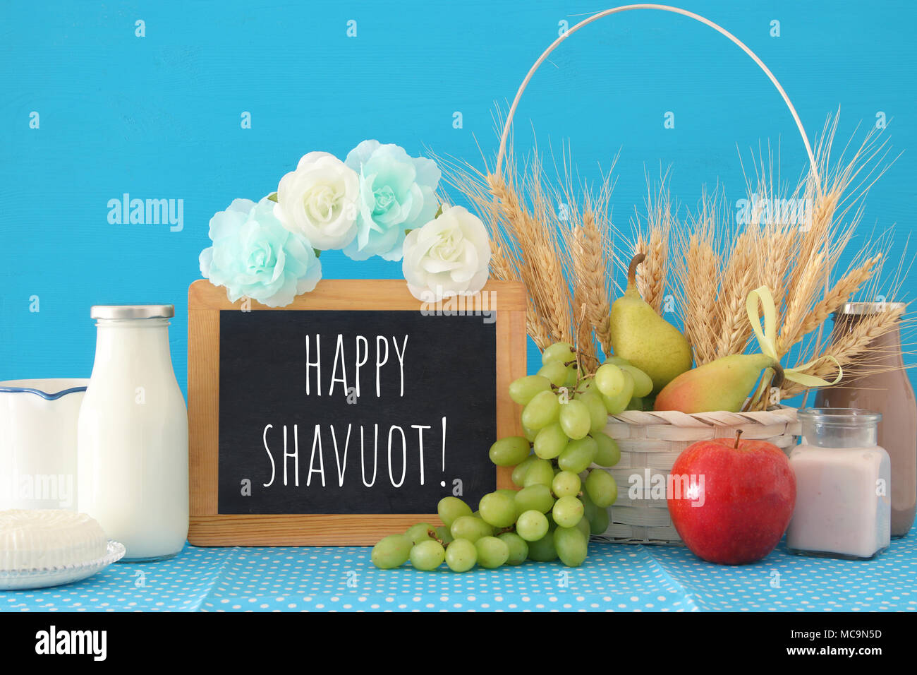 image of dairy products and fruits over wooden table. Symbols of jewish ...