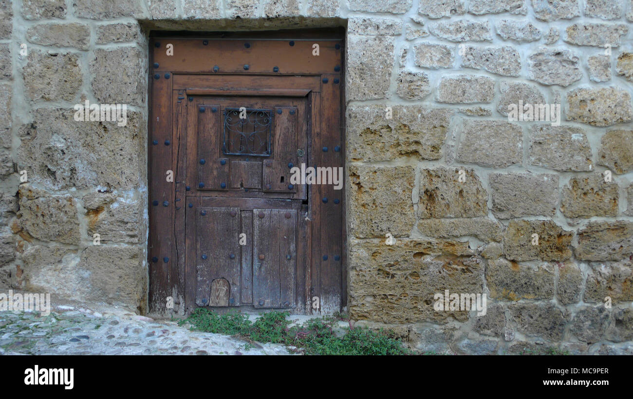 old wooden gate and stone wall Stock Photo - Alamy