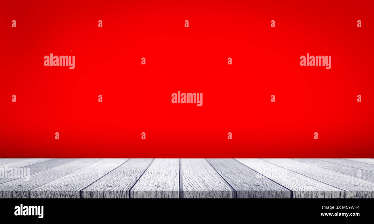 wooden table top with color red background use for products show or ...