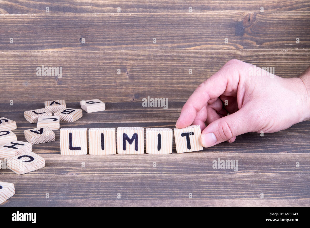 Limit. Wooden letters on the office desk Stock Photo - Alamy
