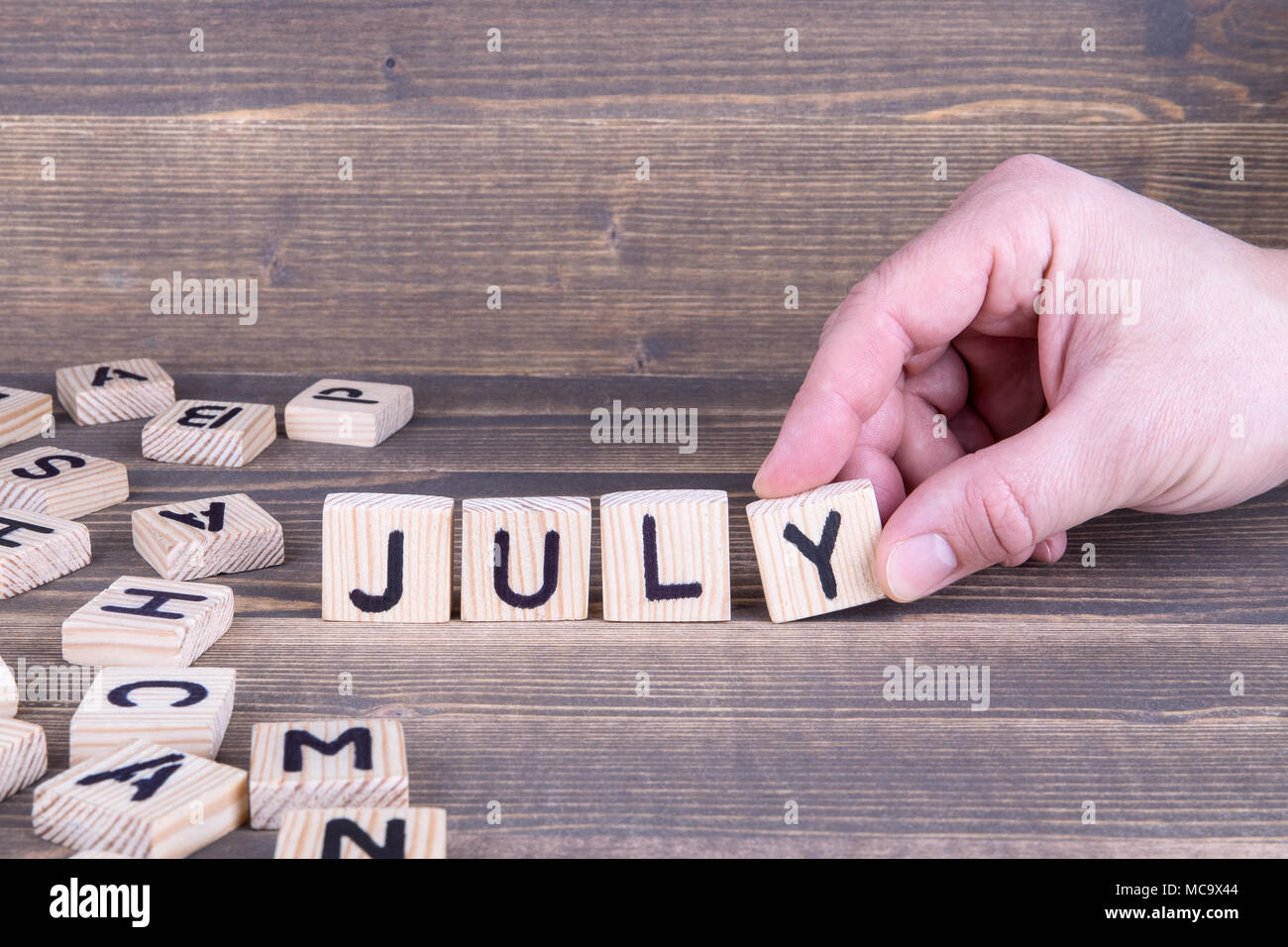 July. Wooden letters on the office desk Stock Photo - Alamy