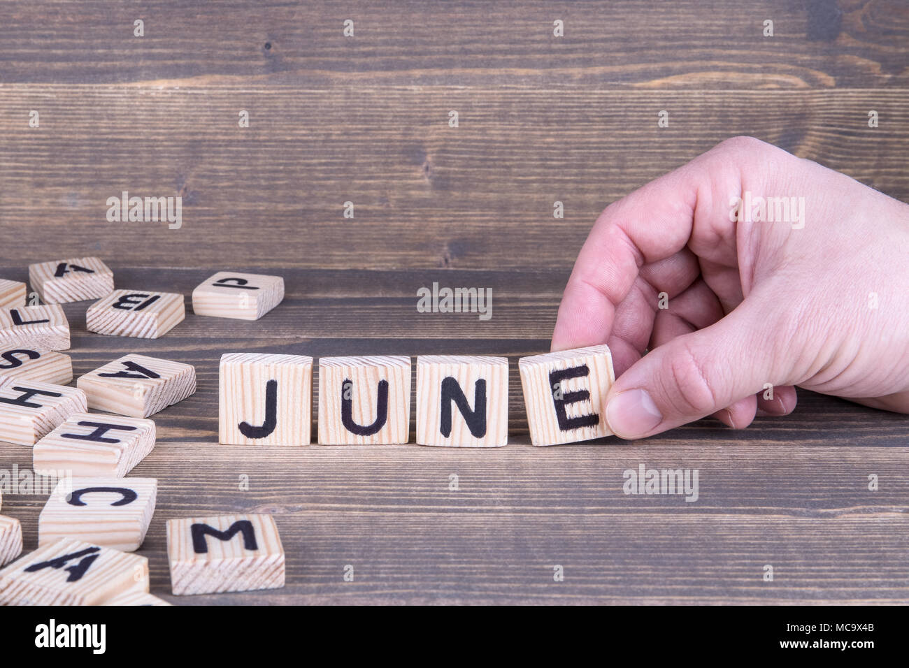 June. Wooden letters on the office desk Stock Photo - Alamy