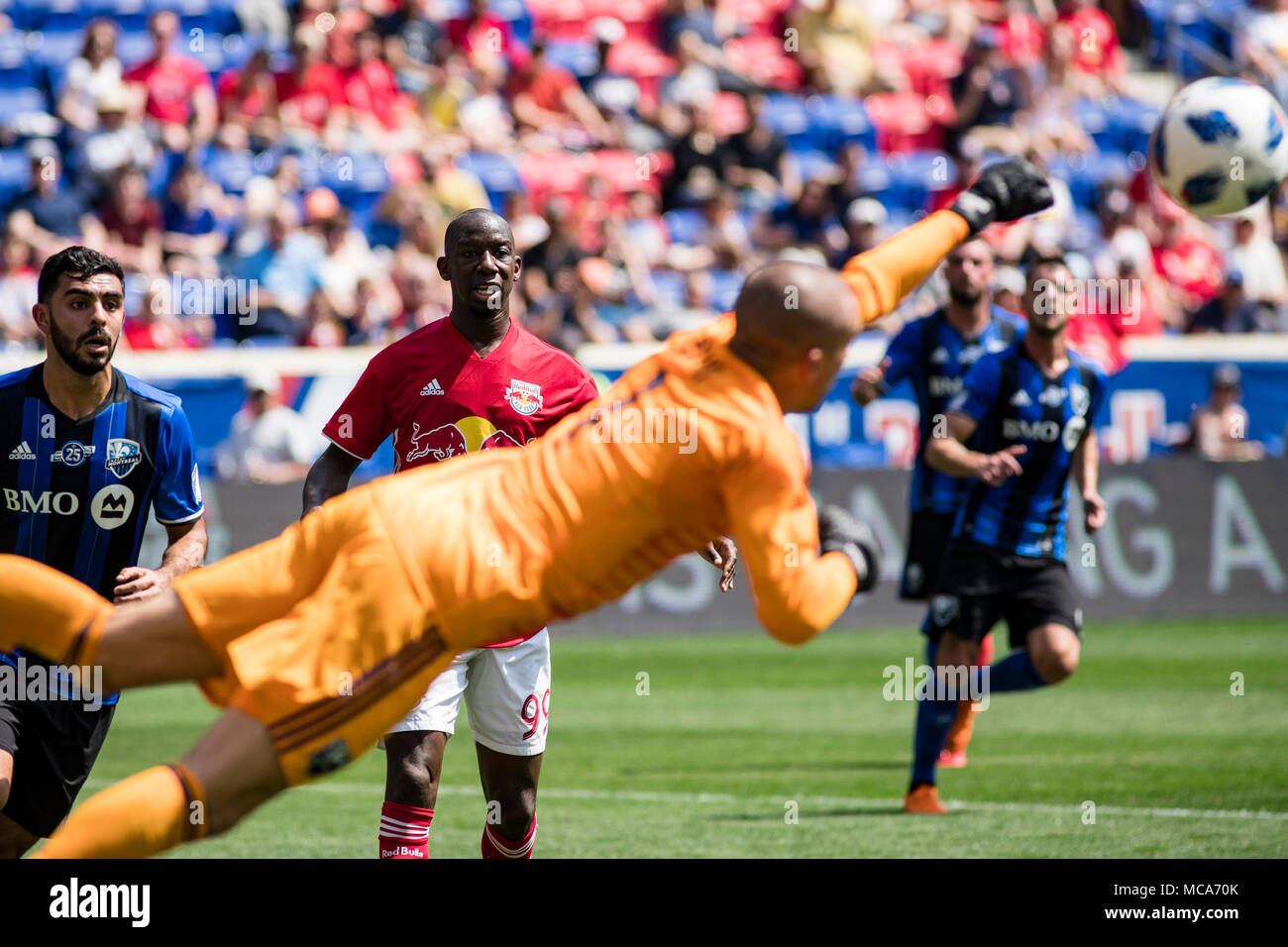 New Jersey, USA. 14th April, 2018. Evan Bush (1) punches away a cross ...