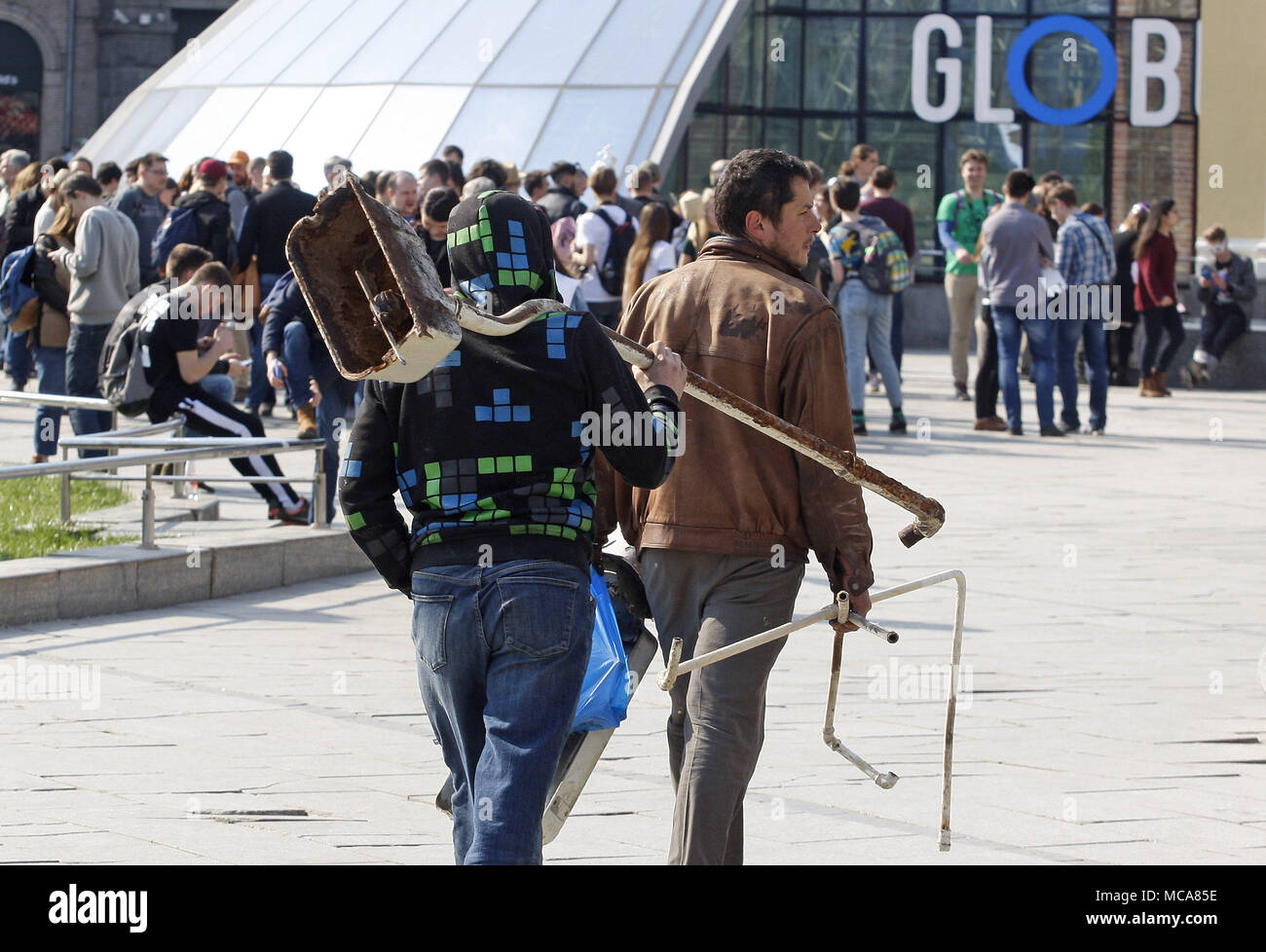 Kiev, Ukraine. 14th Apr, 2018. Men carries in hands parts of the old ...
