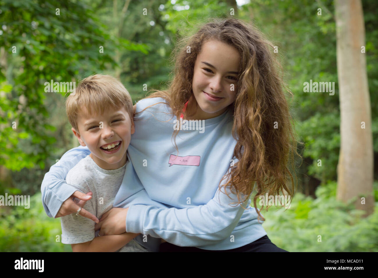Brother and sister having fun in the woods Stock Photo - Alamy