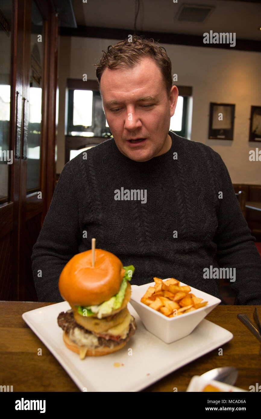 Man eating burger Stock Photo - Alamy