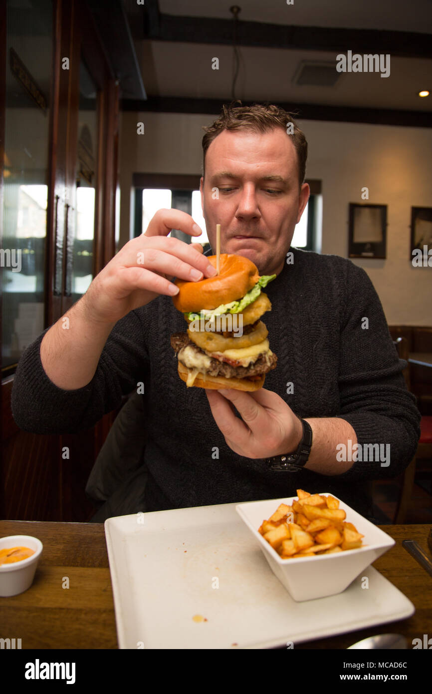 Man eating burger Stock Photo - Alamy
