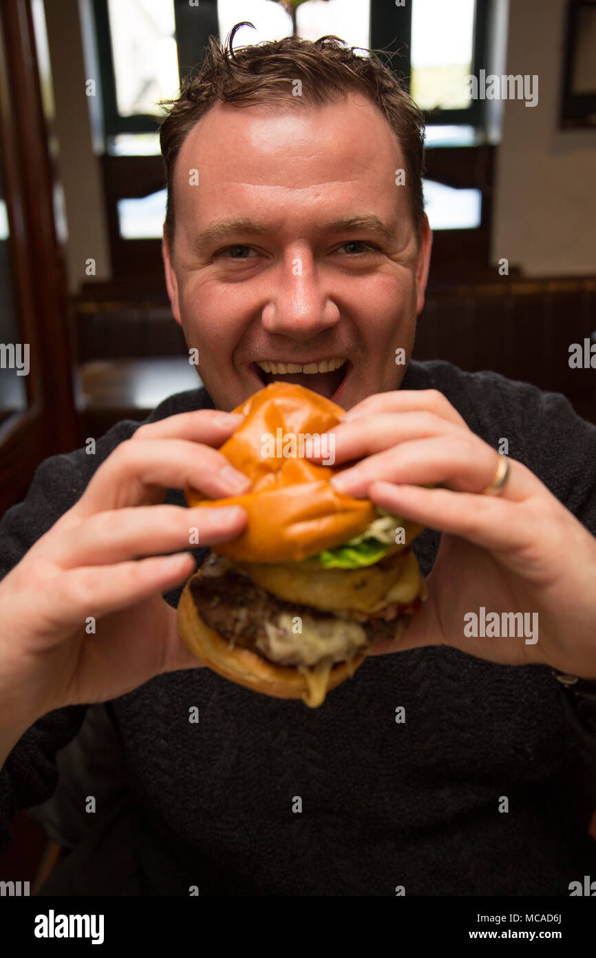 Man eating burger Stock Photo - Alamy