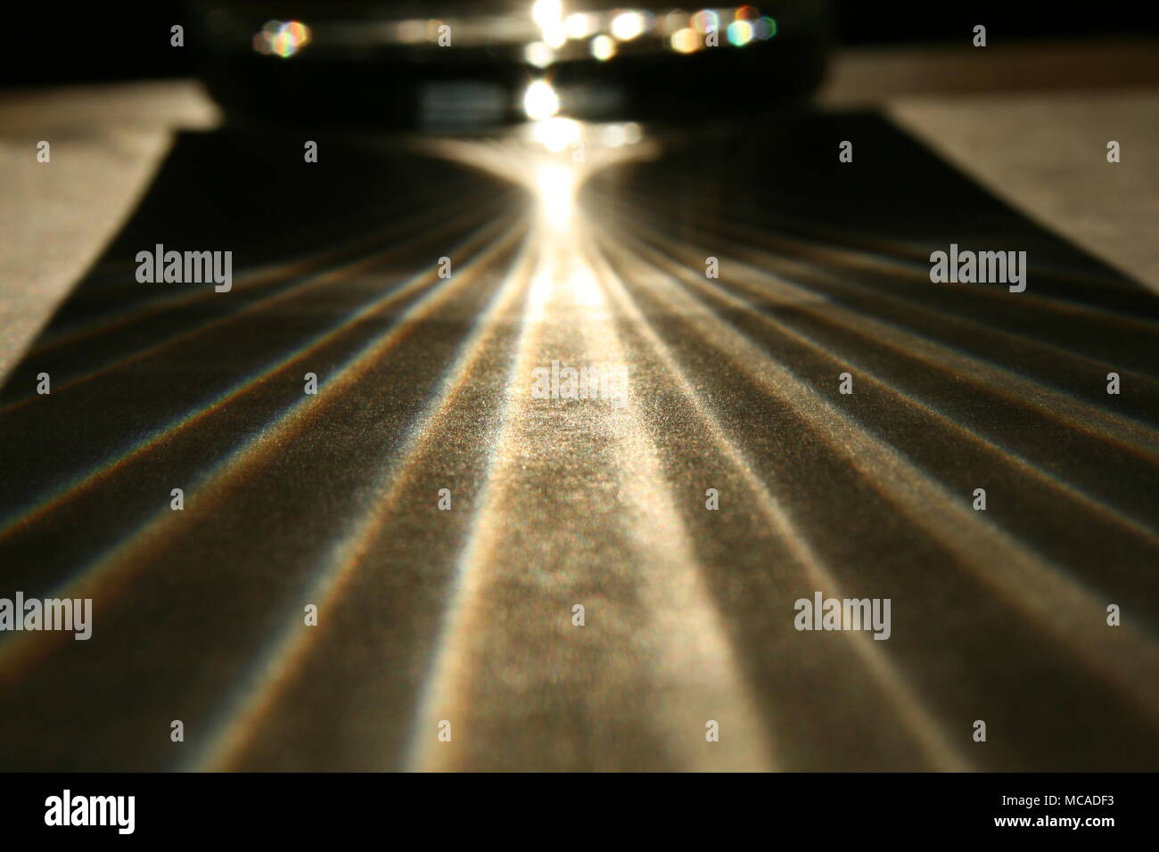 Light splitting through the bottom of a glass of water Stock Photo - Alamy