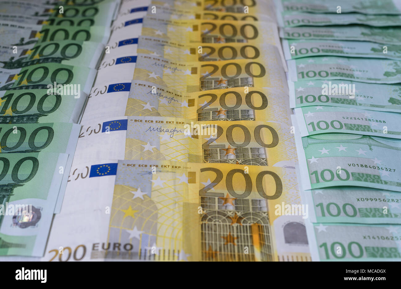 Scattered 200 euro, 100 euro banknotes, European currency - background ...