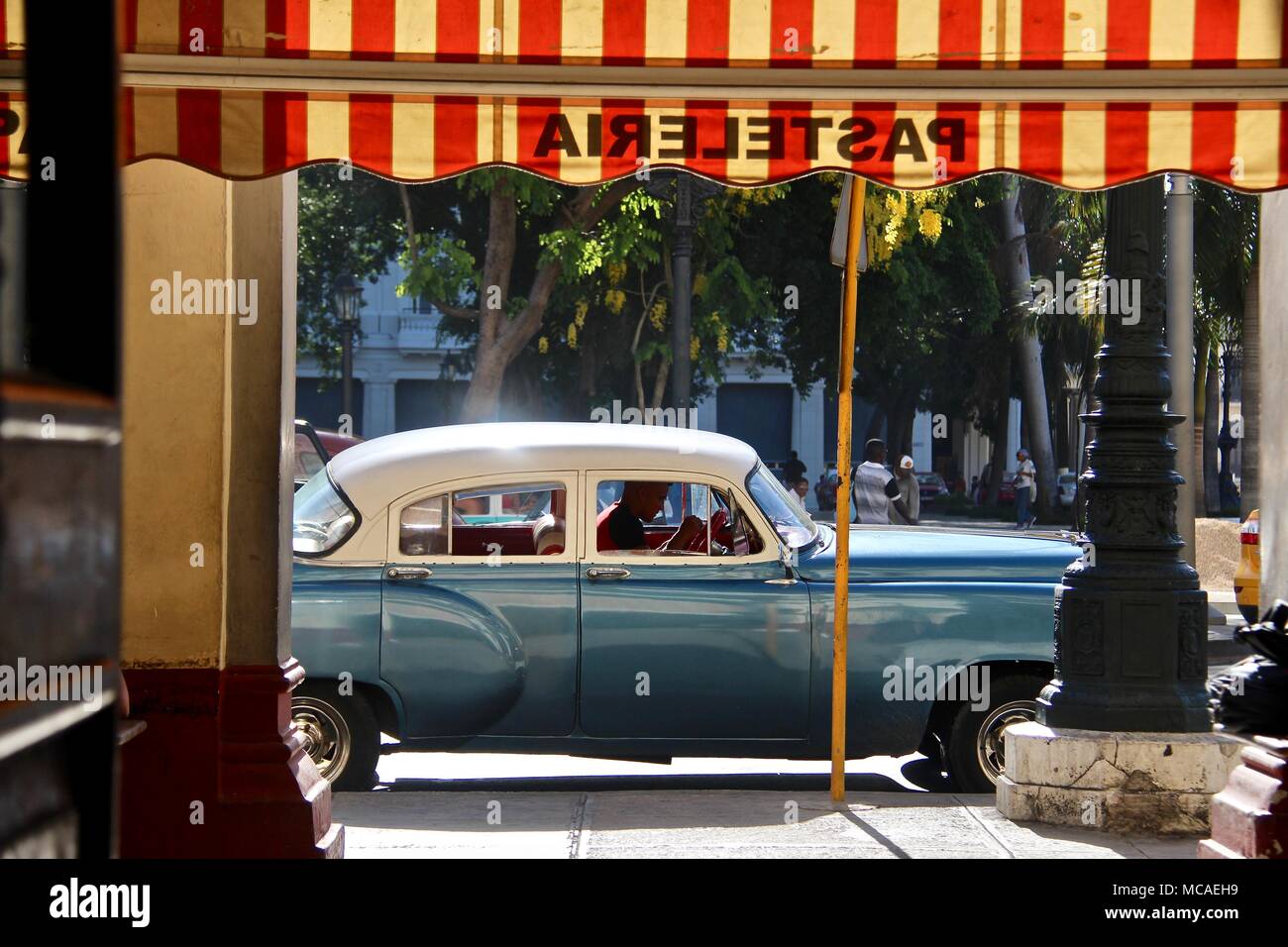 Cuban Taxi driver in blue car Stock Photo - Alamy