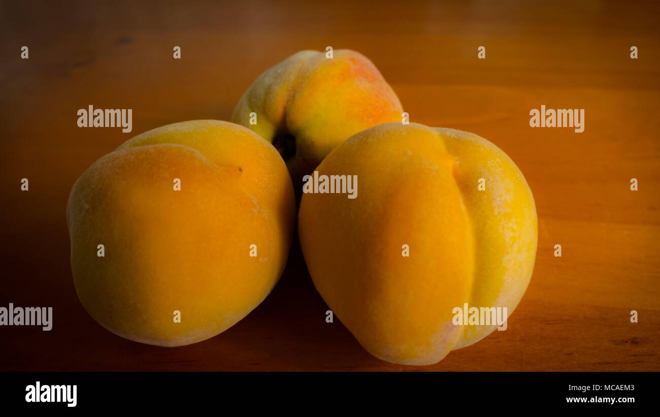 Three juicy ripe peachcot's ready to be devoured Stock Photo - Alamy