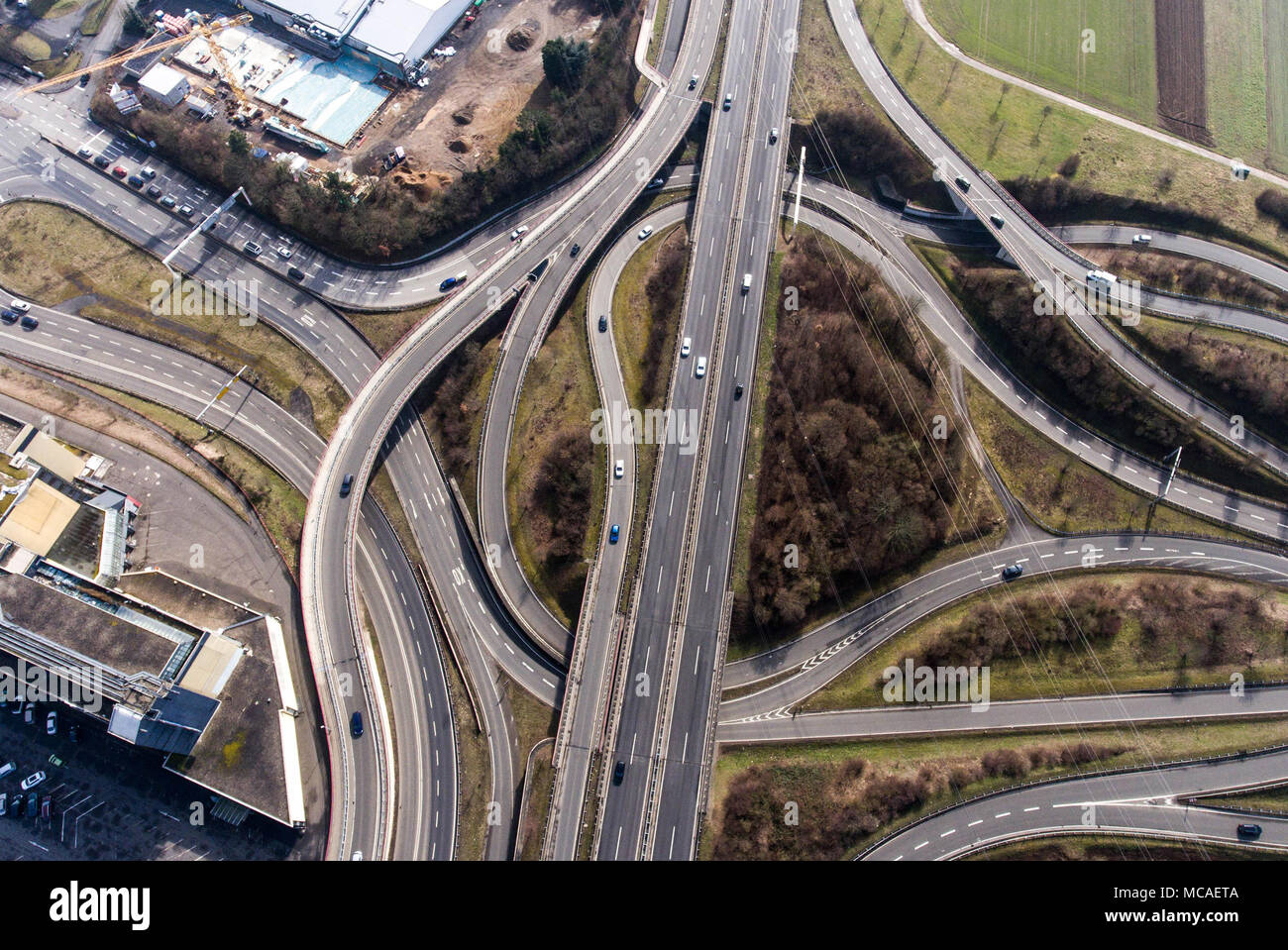 Aerial view of a highway intersection with a clover-leaf interchange in ...