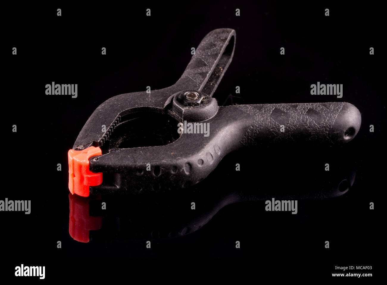 Detail of big clamp against black background Stock Photo - Alamy