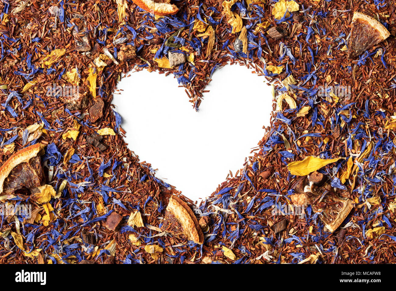 Heart shaped from rooibos tea with cornflower and orange slices on ...