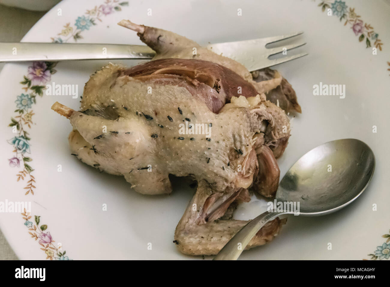 Roast pigeon on a plate ready for dinning. Close-up shot Stock Photo ...
