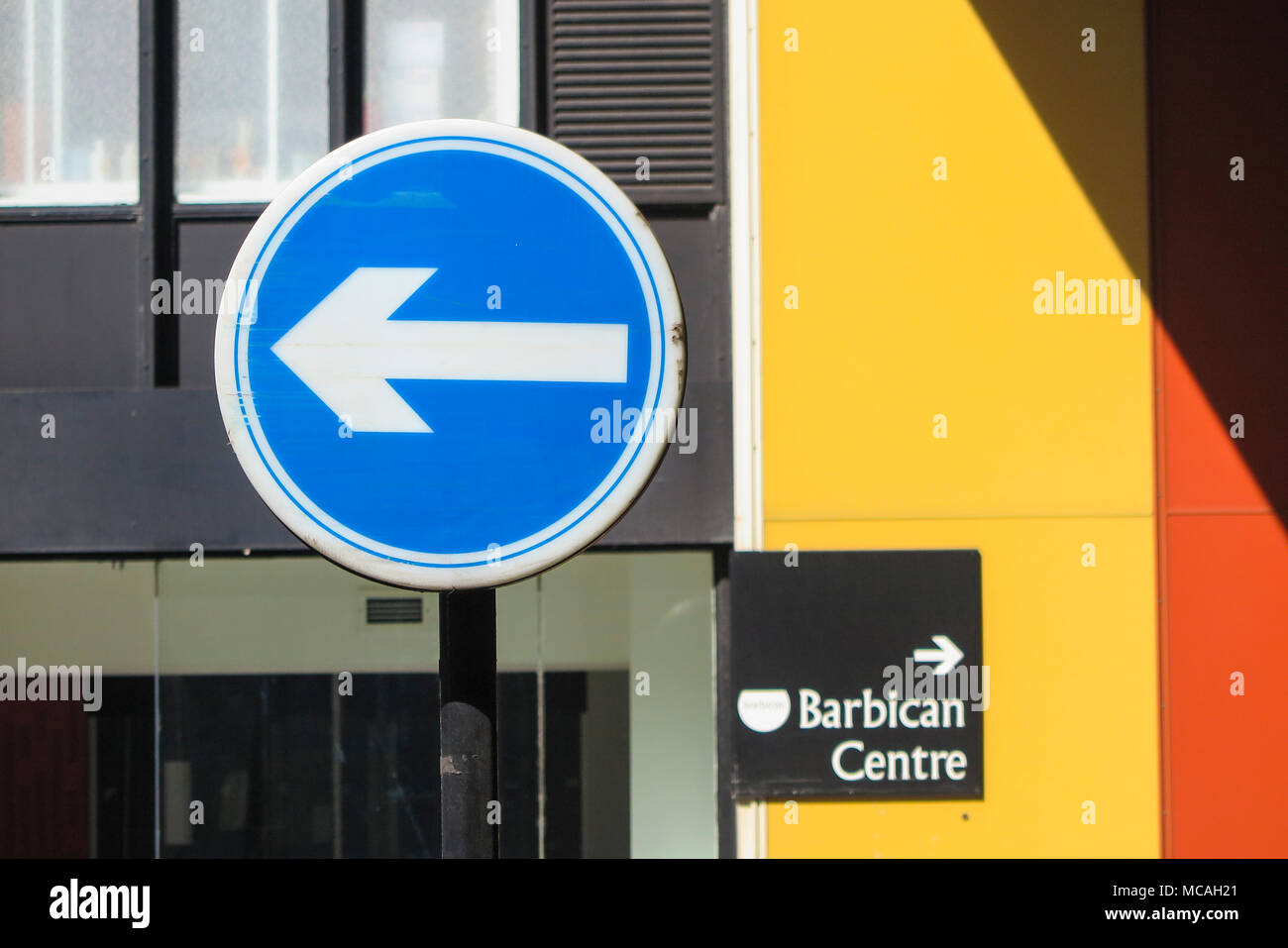 A one way sign to the left and a sign towards the Barbican Centre on ...