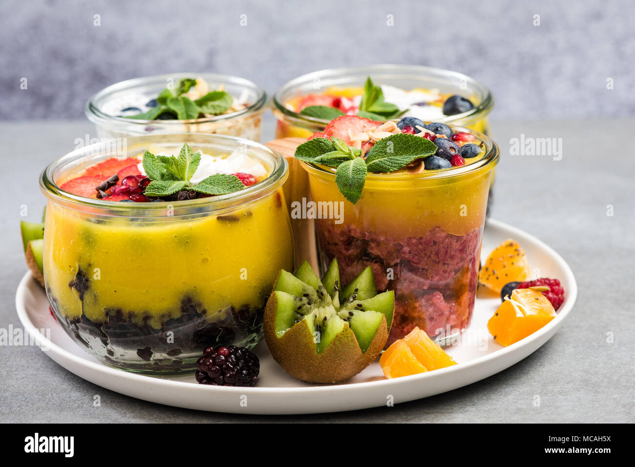 Ripe fruits and superfoods jars, layered food Stock Photo - Alamy
