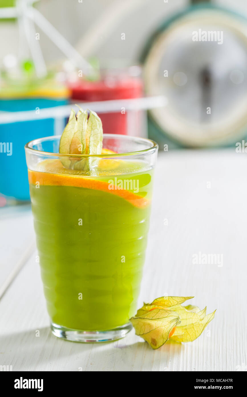 Green smoothie with fruity yogurt on white table Stock Photo - Alamy