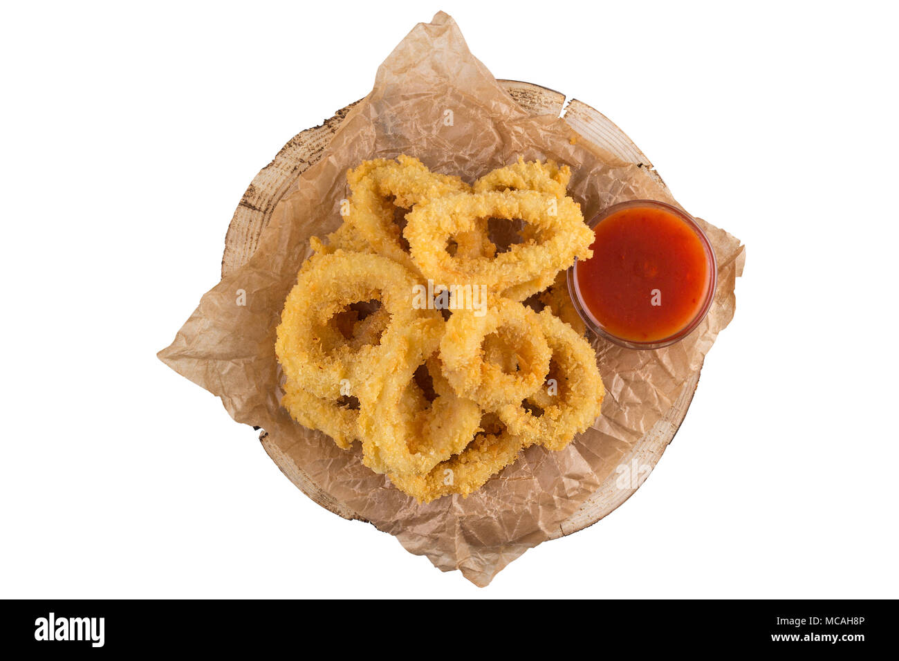 Ornate squid rings in tender batter with greens on a white background ...