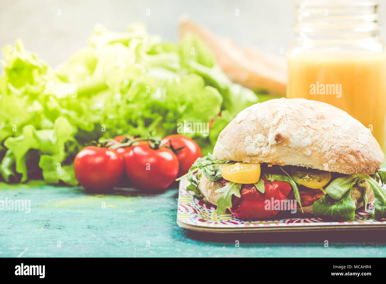 Diet bun with fresh vegetables and smoothie Stock Photo - Alamy