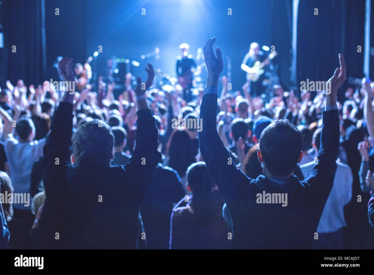 The audience watching the concert on stage Stock Photo - Alamy