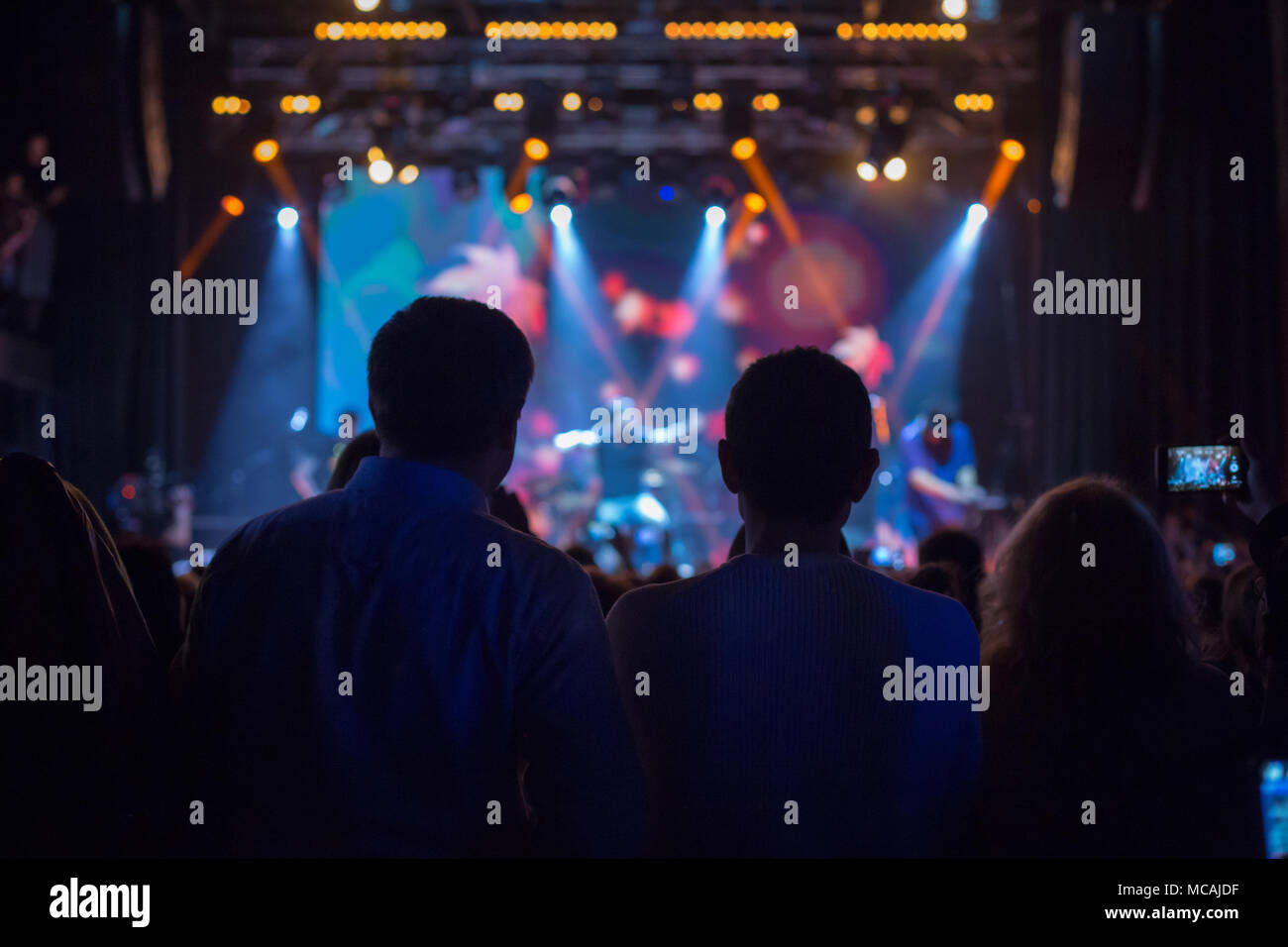 The audience watching the concert on stage Stock Photo - Alamy